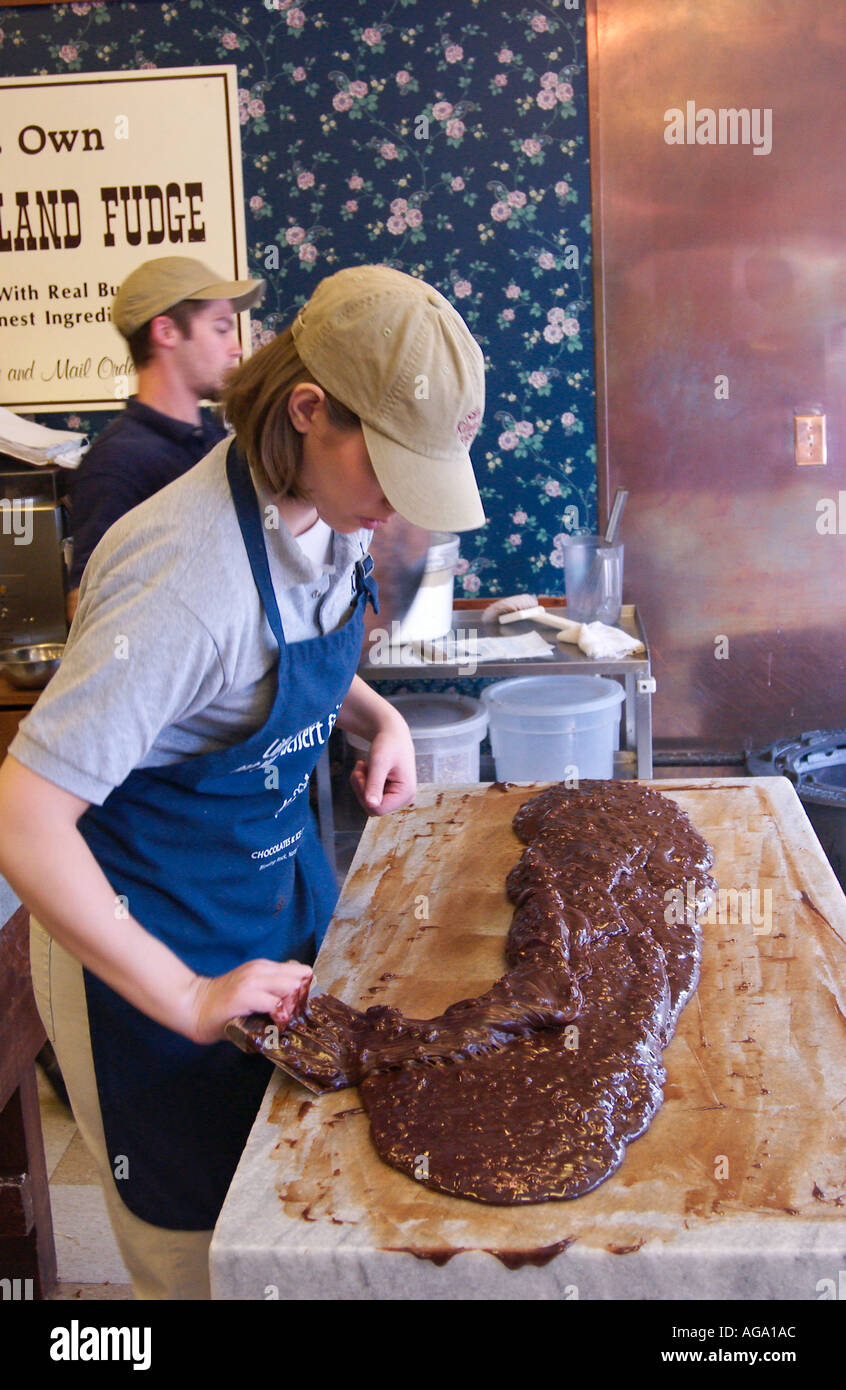 A young man preparing homemade fudge in a charming candy store nestled ...