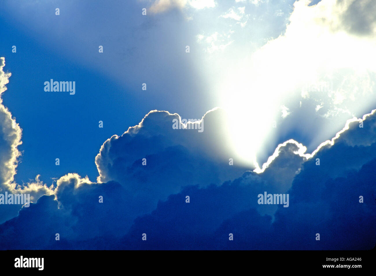Sun Rays bursting through clouds Stock Photo - Alamy