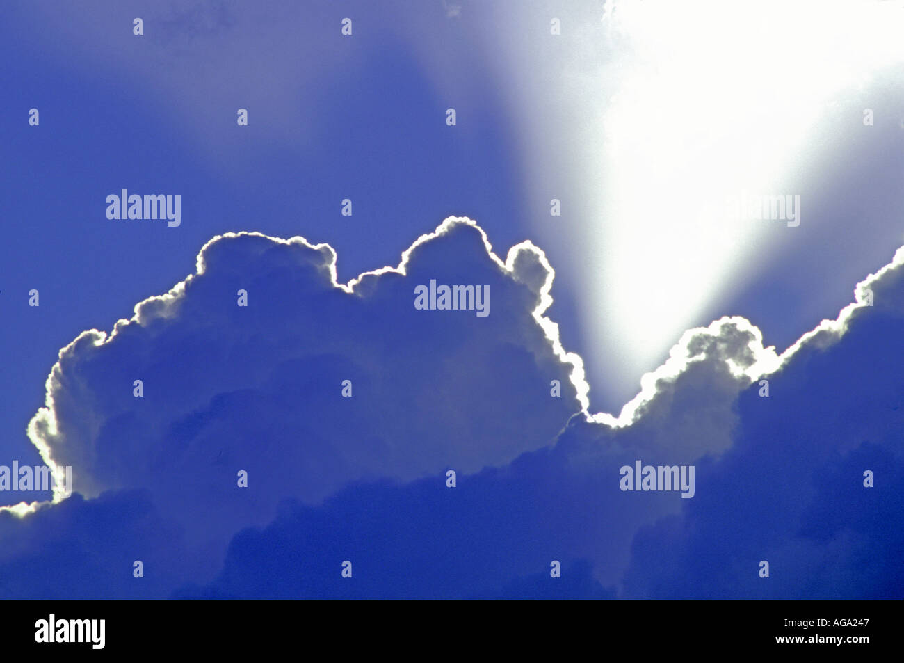 Sun Rays bursting through clouds Stock Photo - Alamy