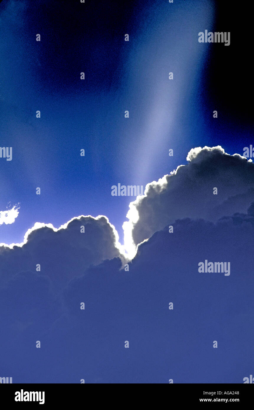 Sun Rays piercing through clouds Stock Photo - Alamy