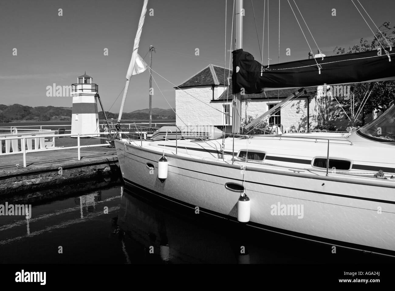 Black and White view of yacht and lighthouse in Crinan Harbour Argyll ...