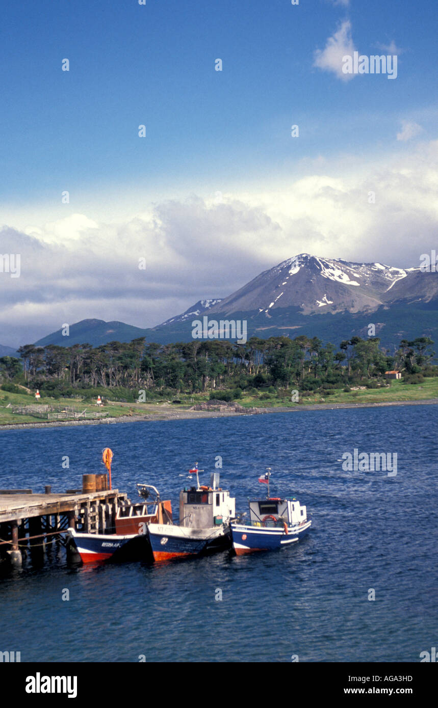 Chile South America Punta Arenas fishing boats snow-capped mountains in ...