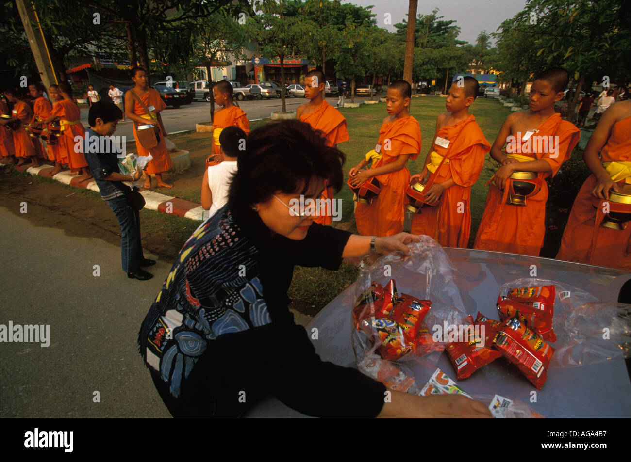 Handing out gifts of food and snacks to novice monks at Songkran the ...