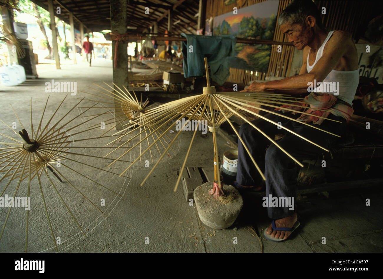 Making parasols in a parasol factory on the road to San Kamphaeng ...
