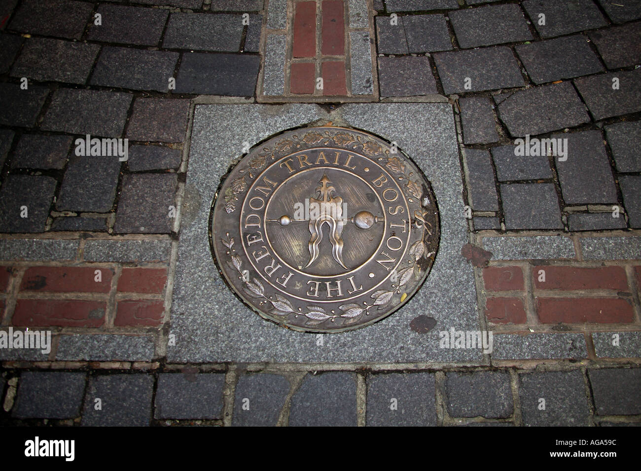 Bronze seal in cobblestone sidewalk with red bricks marks the Freedom ...