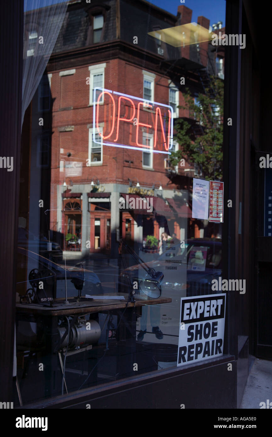 Old treadle sewing machine inside shoe repair shop window with ...