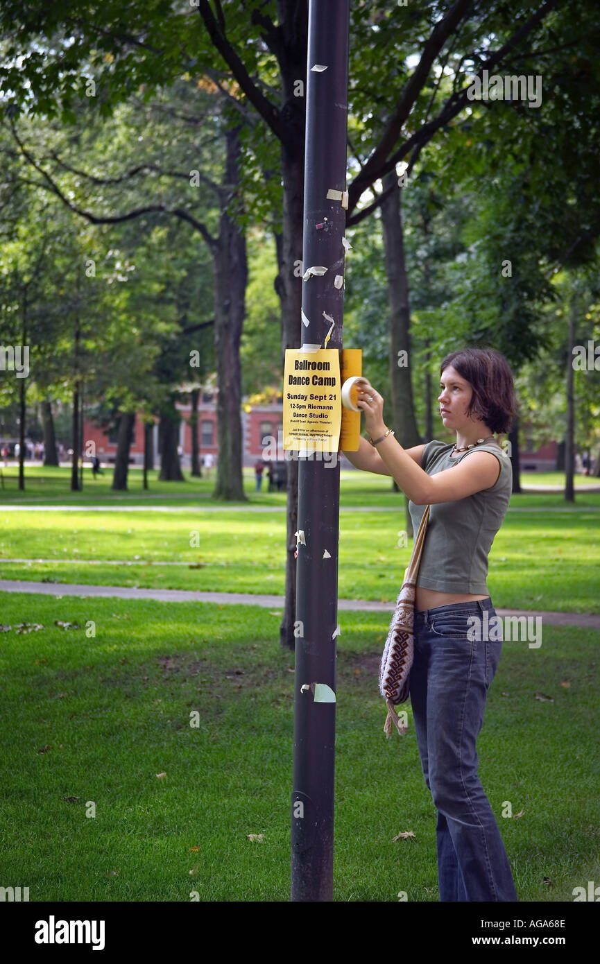 Student posting event notice on post in Harvard Yard Harvard University ...