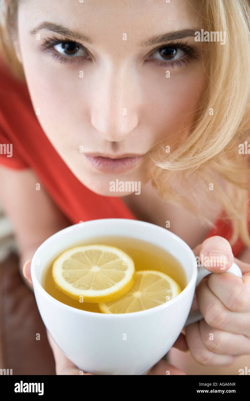 woman drinking lemon tea Stock Photo - Alamy