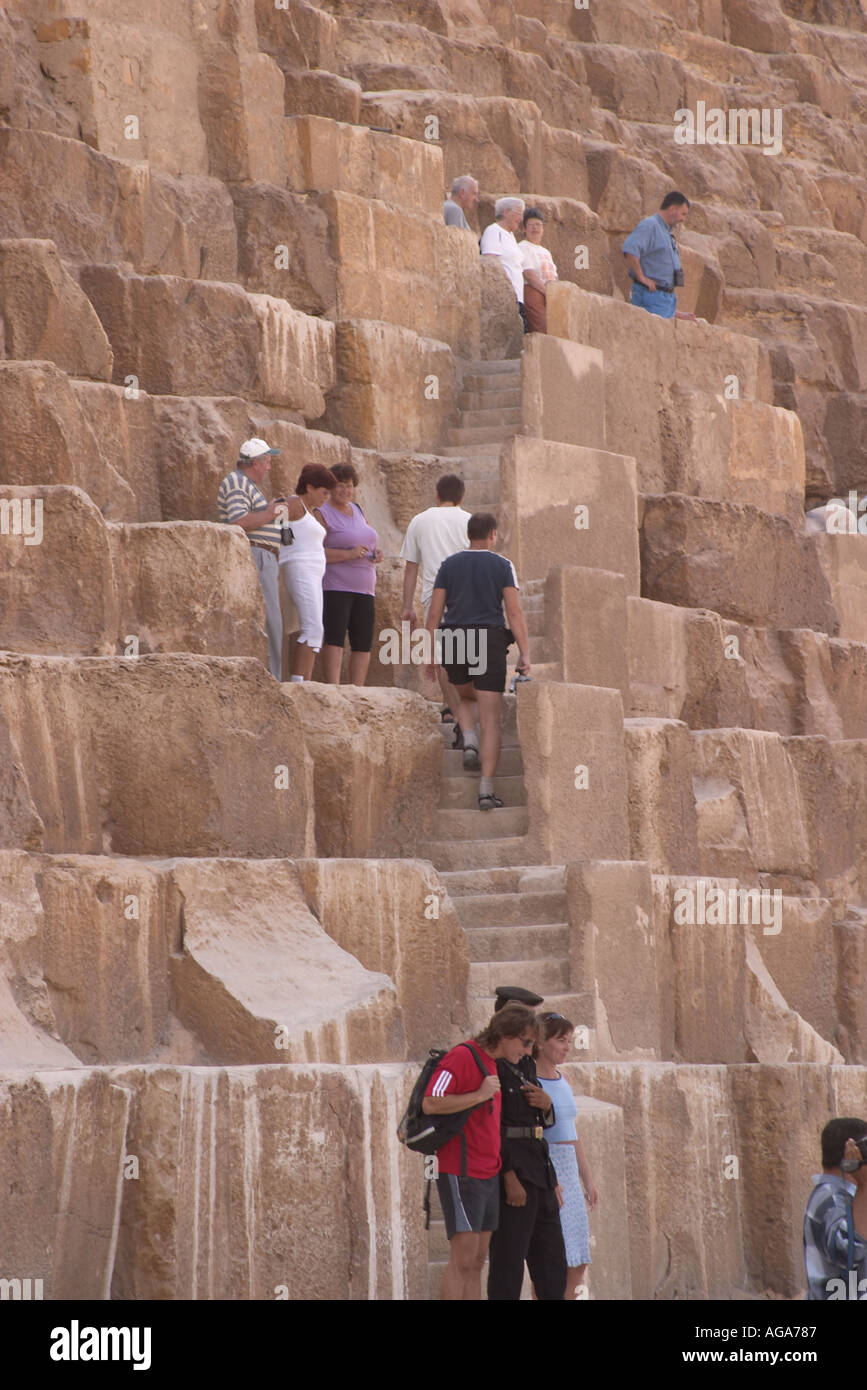 tourists walking up stairs to the enterance of cheops pyramid at giza ...