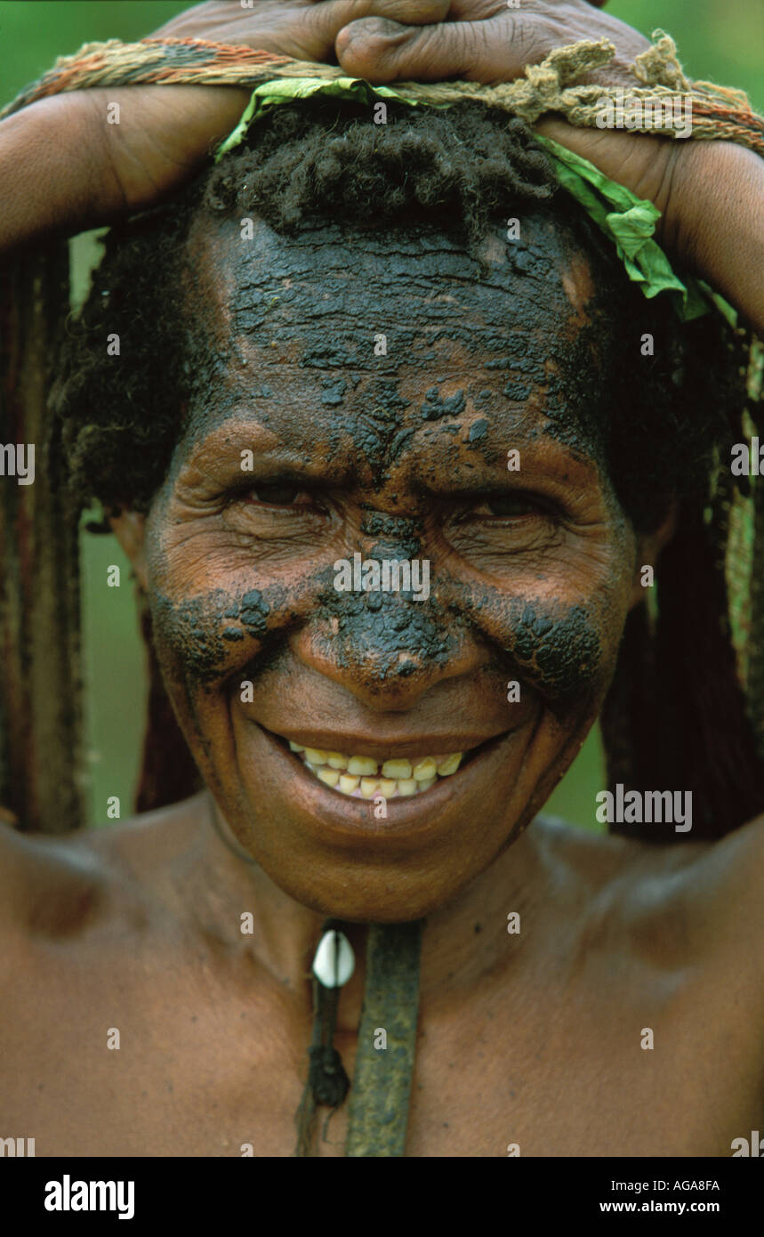 Dani woman her face smeared with soot and pig grease Irian Jaya ...