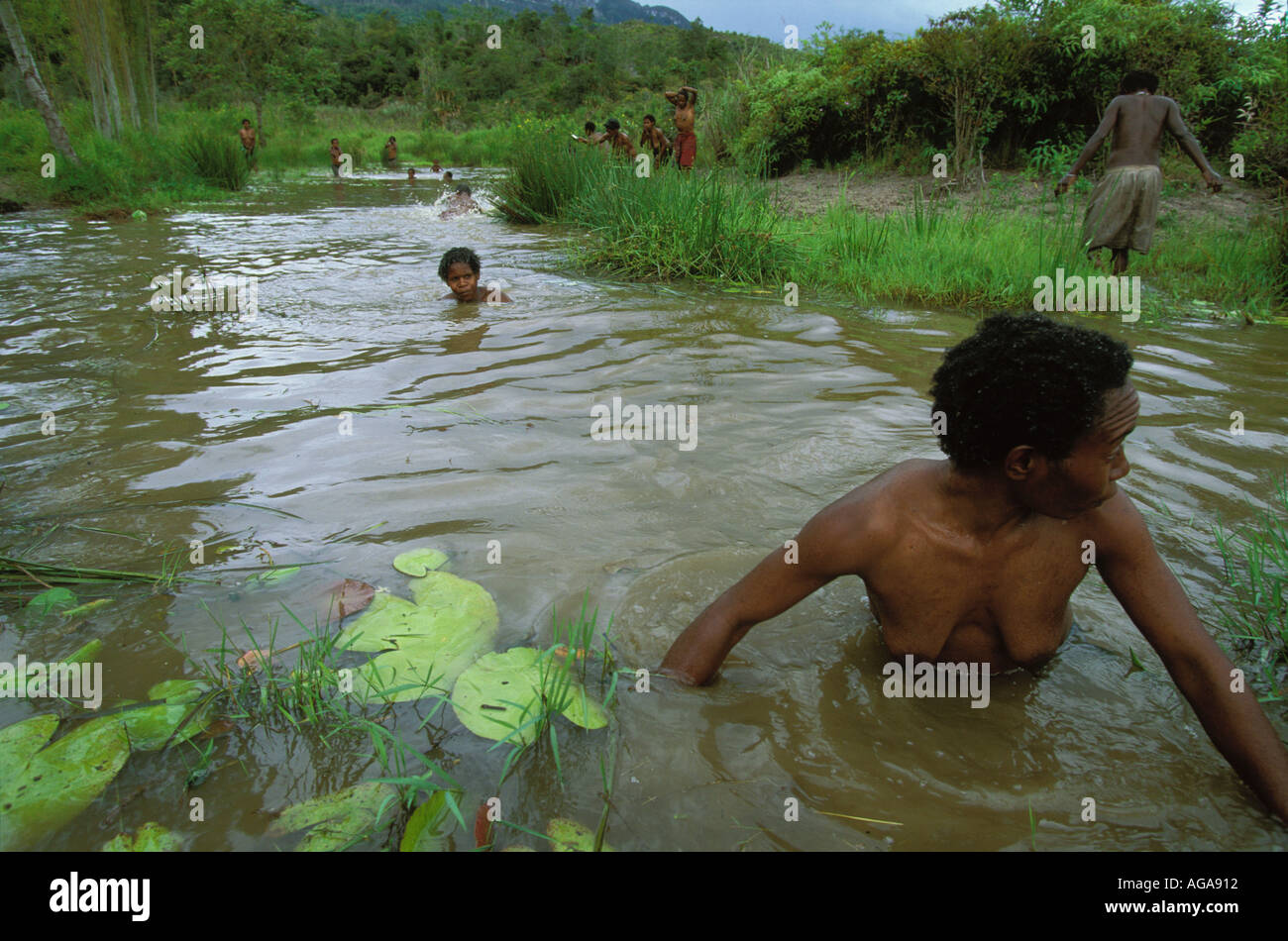 Women wash themselves after participating in a ritual mud battle during ...