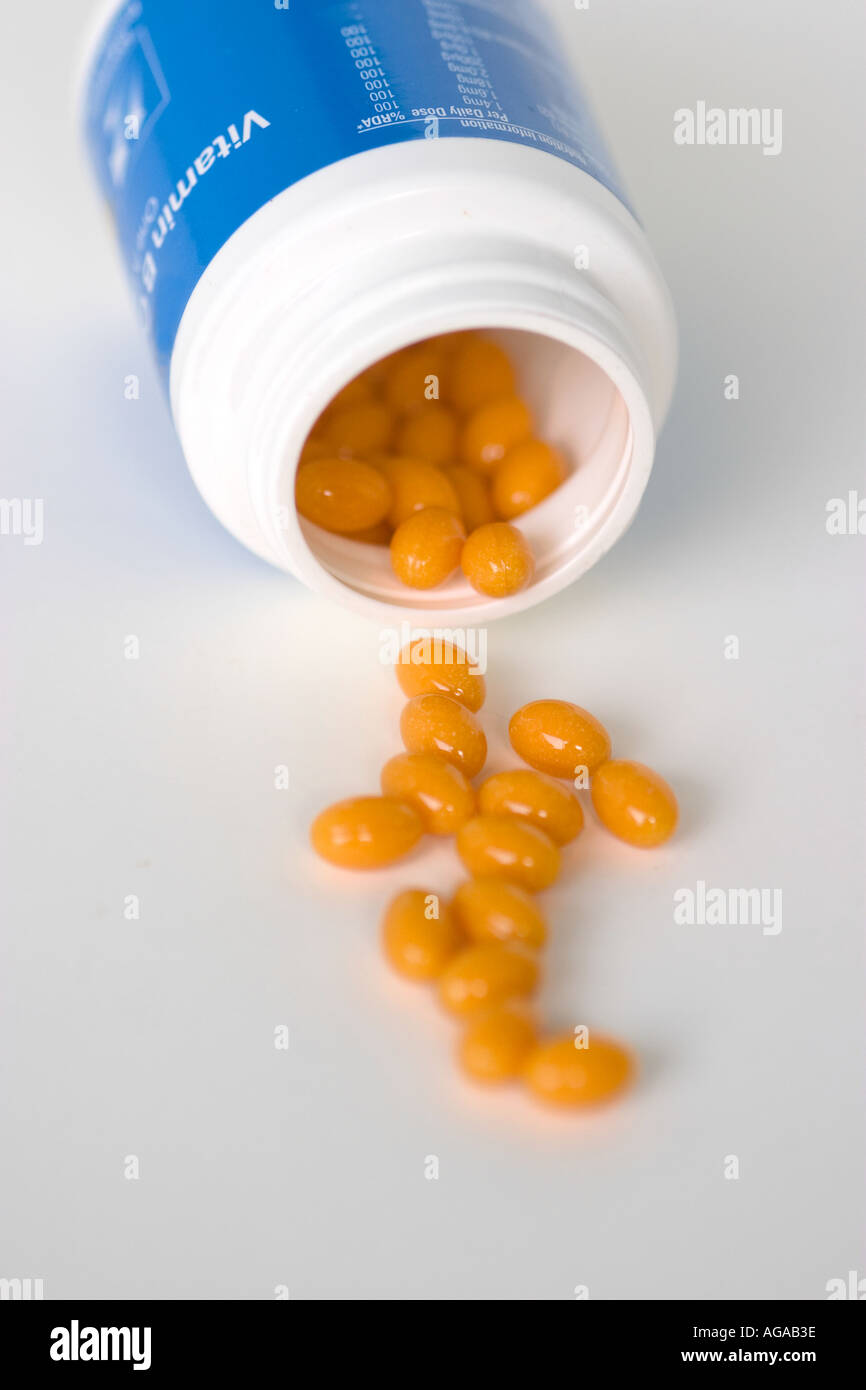 Yellow Vitamin Pills Spilling from Open Container Stock Photo - Alamy