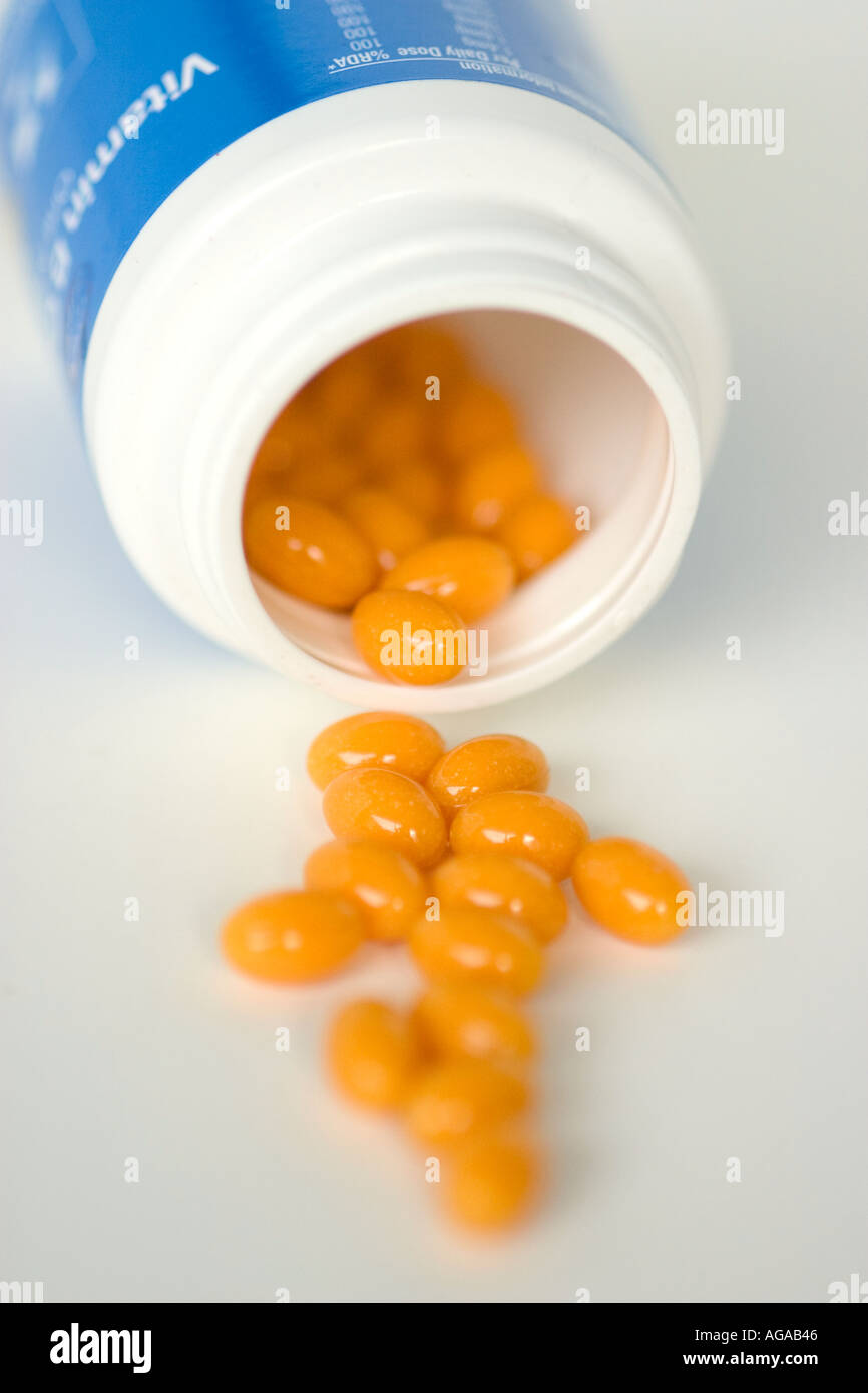 Yellow Vitamin Pills Spilling from Open Container Stock Photo - Alamy