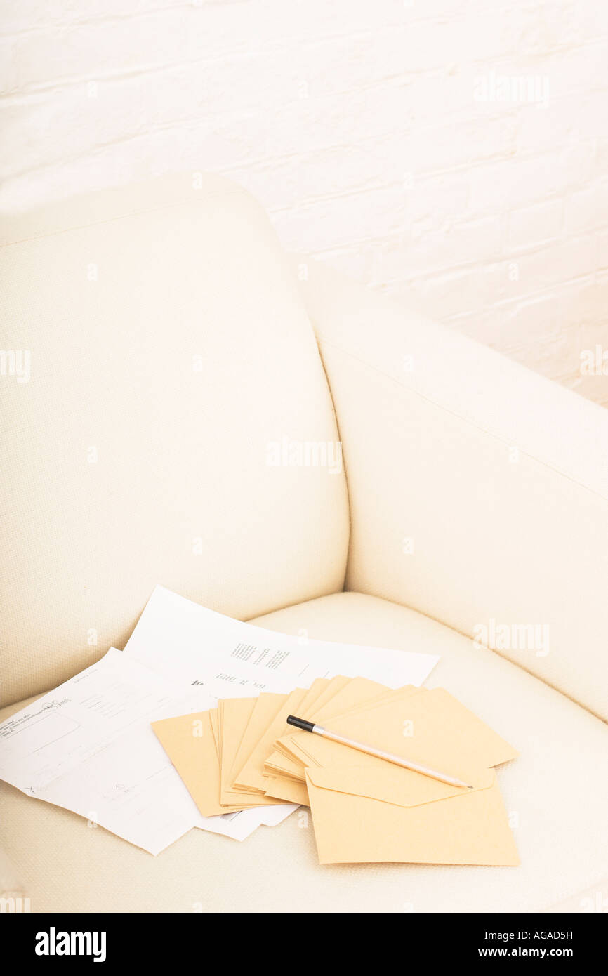 still life of pen and papers on white arm chair Stock Photo - Alamy