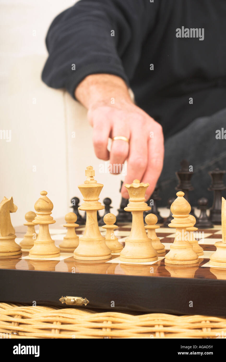 detail of man playing chess at home Stock Photo - Alamy