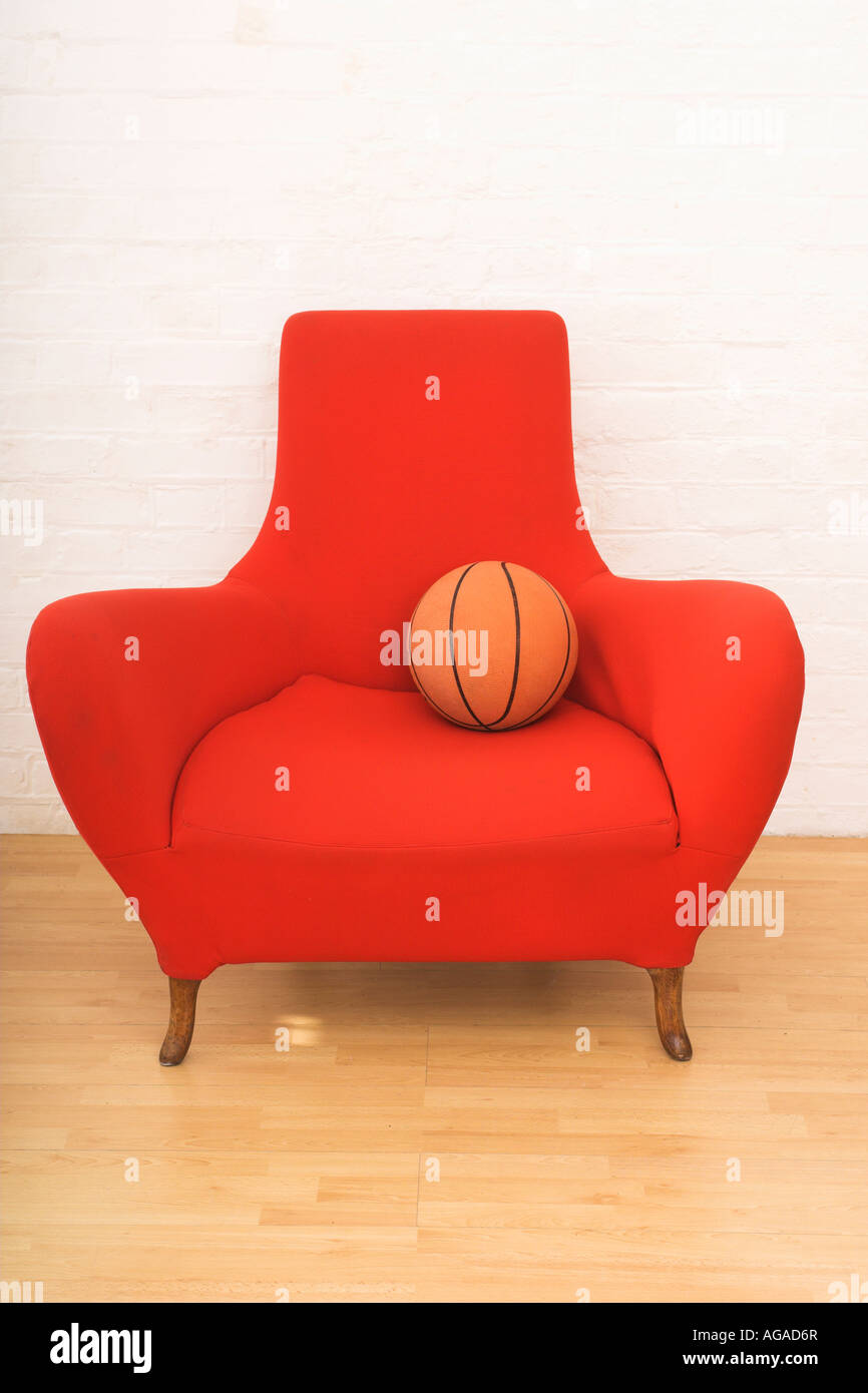 still life of basketball on red arm chair Stock Photo - Alamy