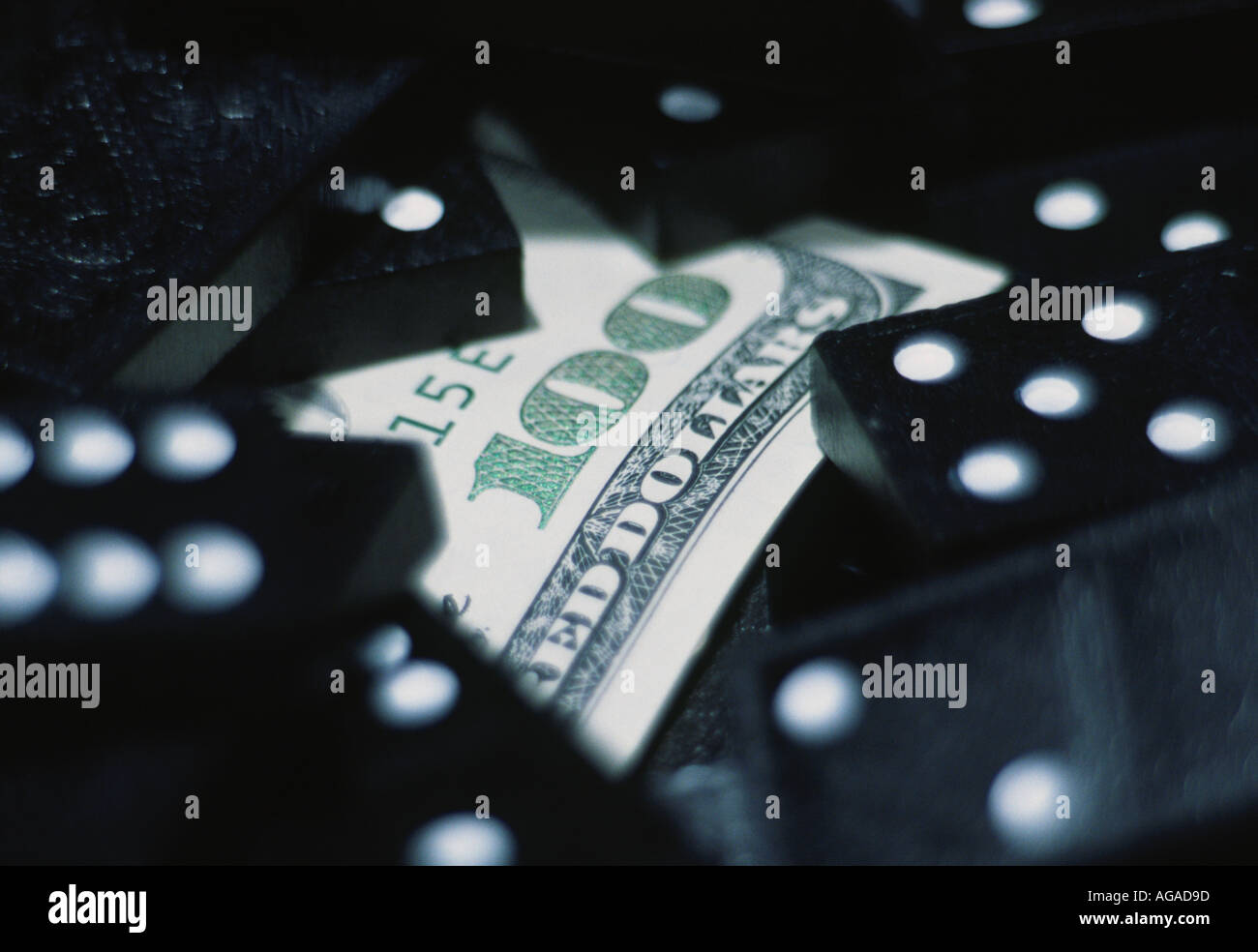 US dollar in pile of domino bricks Stock Photo - Alamy