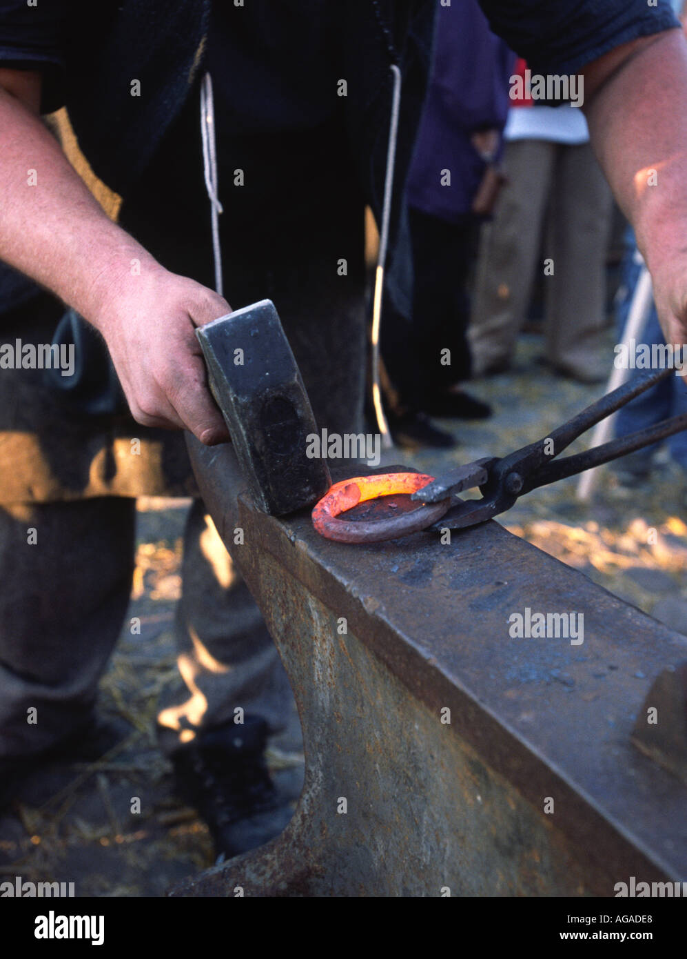Blacksmith forging an iron ring on an anvil Stock Photo - Alamy