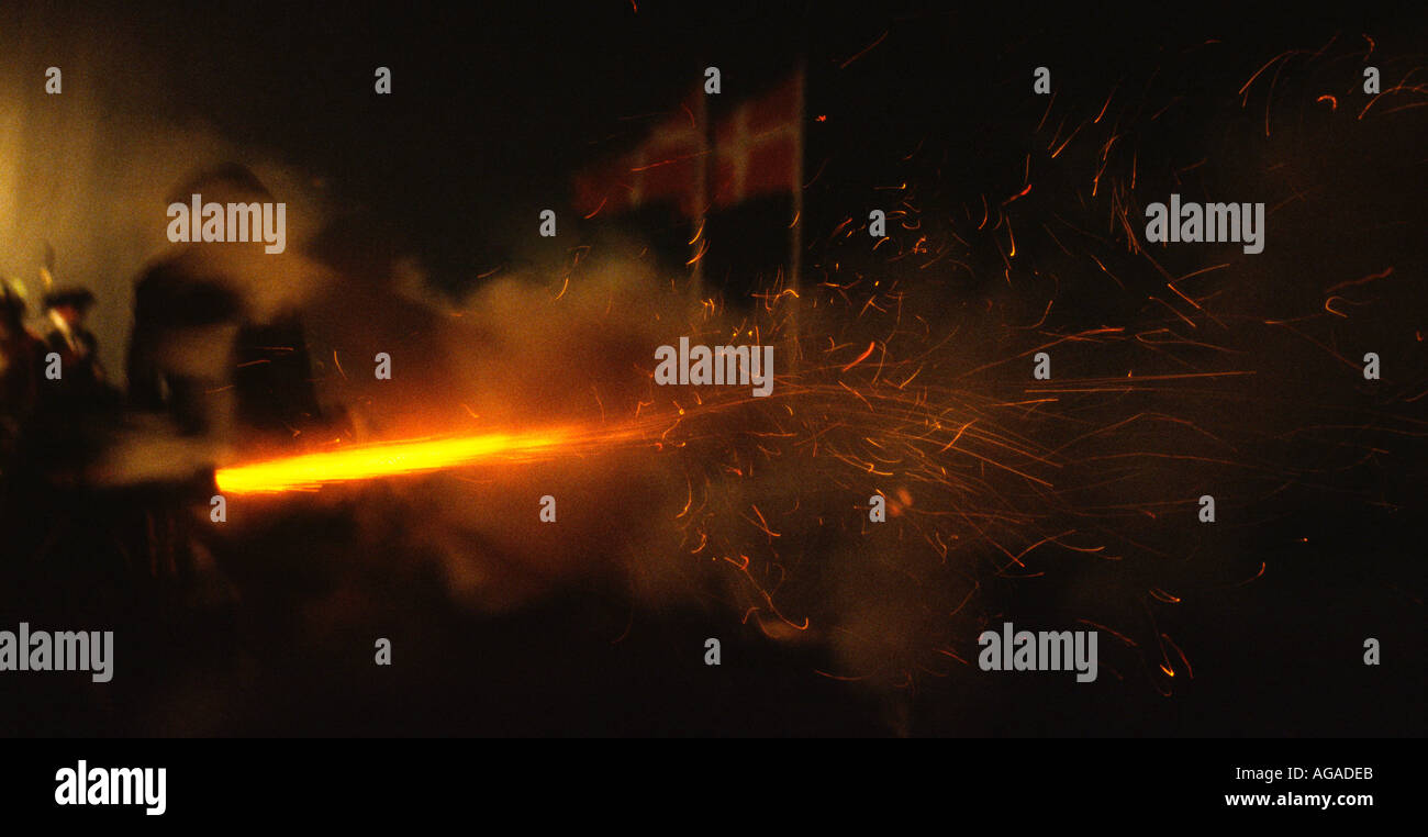 Cannon fire, with the Danish flag, Dannebrog, in the background Stock ...