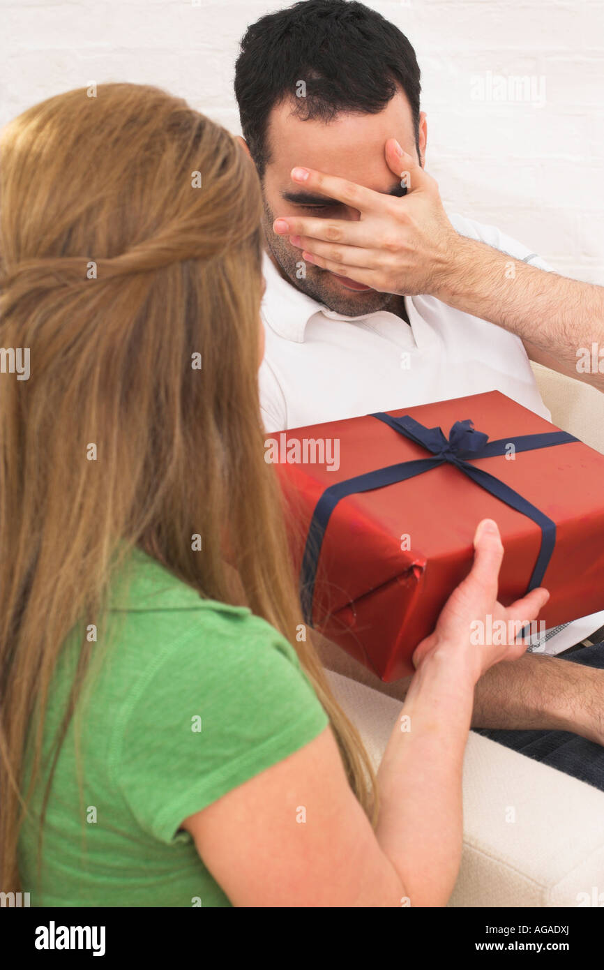 young woman giving present to man Stock Photo - Alamy