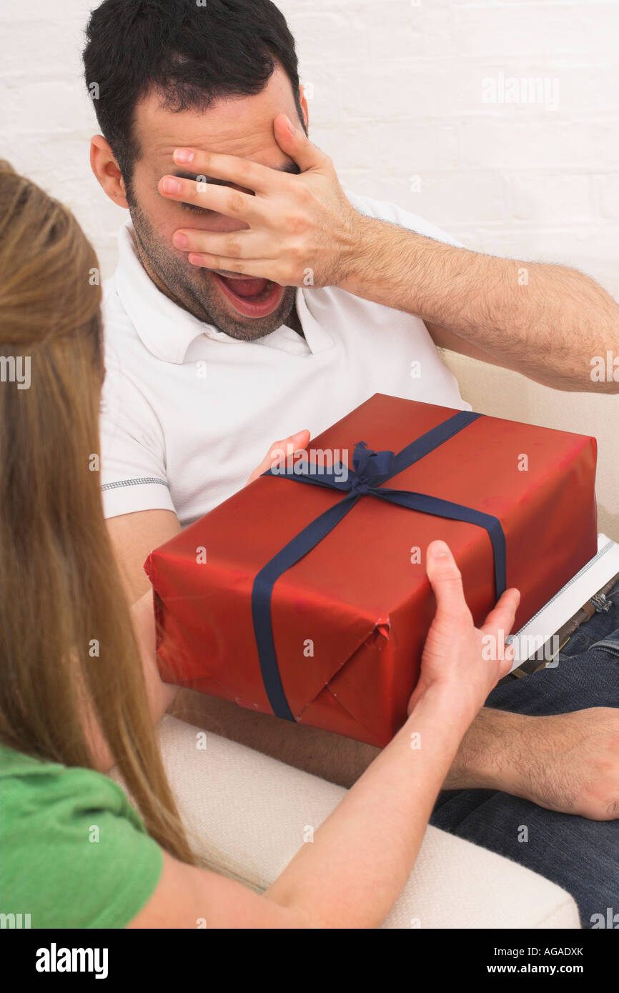 young woman giving present to man Stock Photo - Alamy