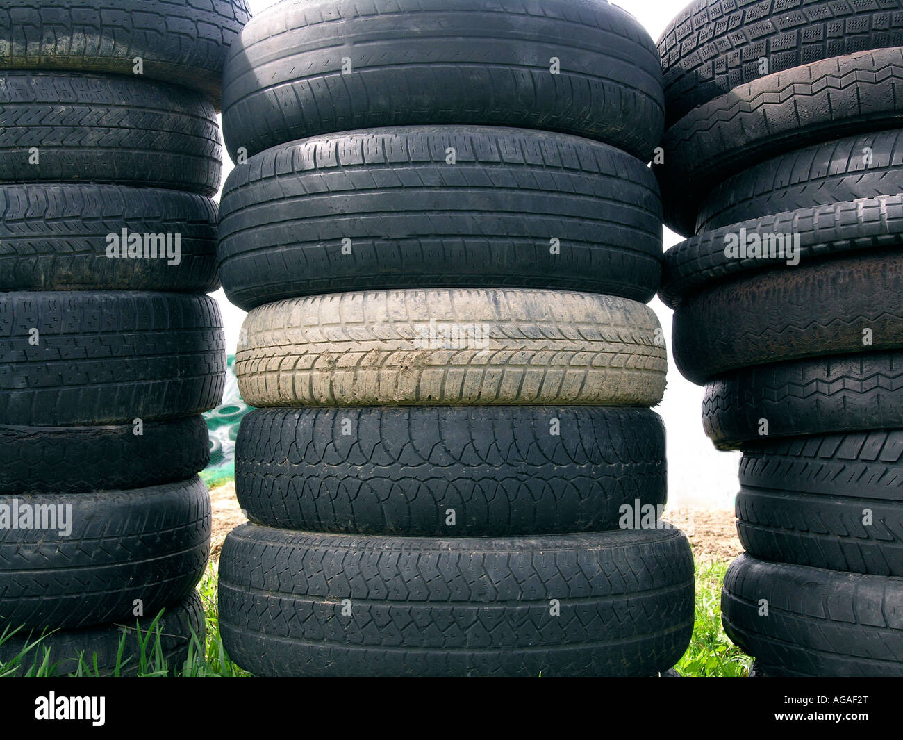 Old rubber tyres in the countryside Stock Photo - Alamy