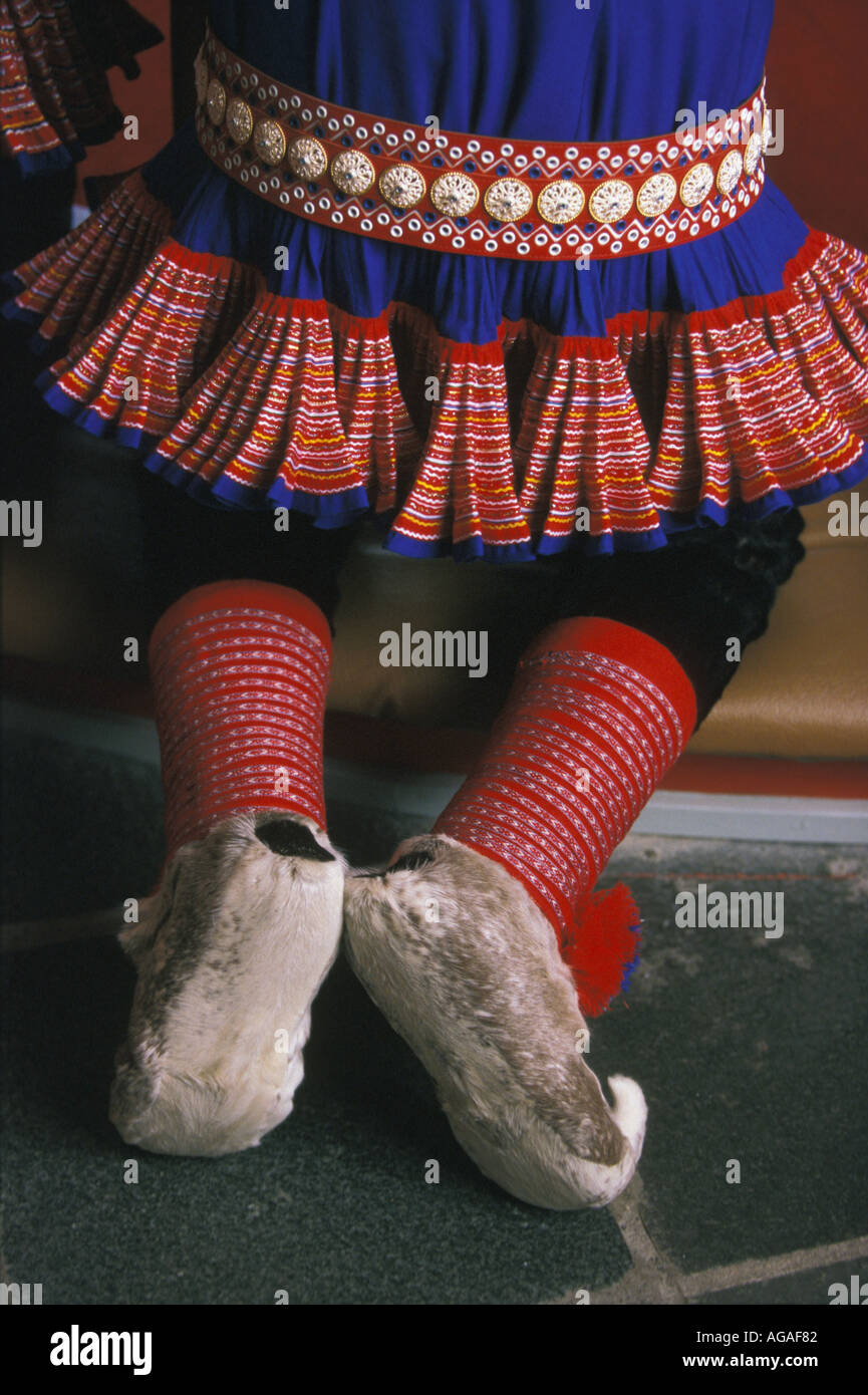 Saami boy in traditional costume kneels by the altar at a confirmation ...