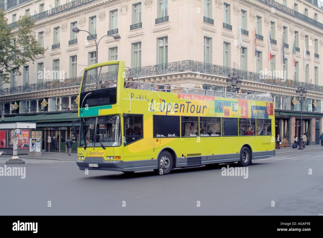 Paris open top tour bus passing The Grand Hotel in the Place de L Opera ...