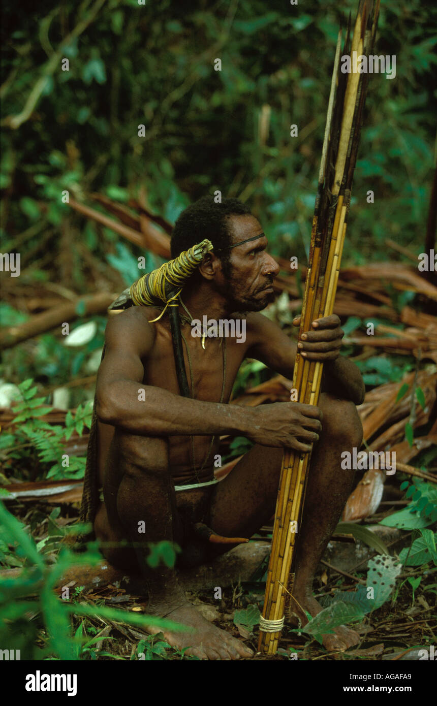 Man with stone axe and bow and arrows The Kombai tribe Treehouse People ...
