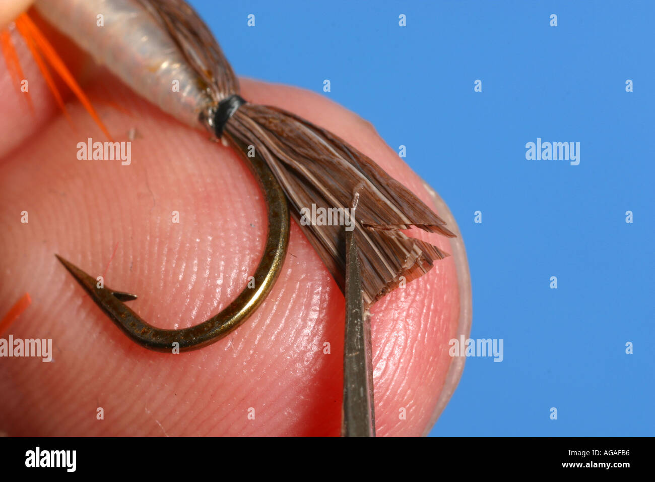fishing fly Cutting tail to shape on Polystickle fly Stock Photo - Alamy