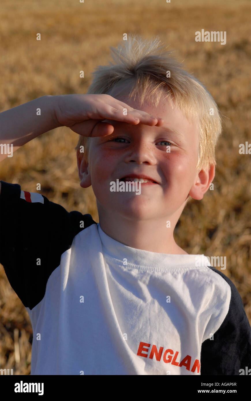 Portrait of a young boy saluting Stock Photo - Alamy