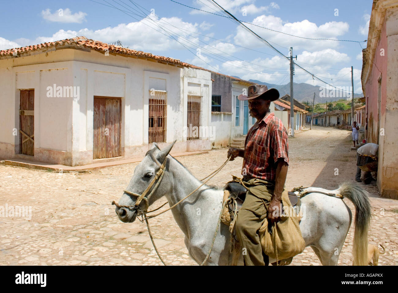 Campesino on horseback visiting riding through Trinidad, Cuba Stock ...