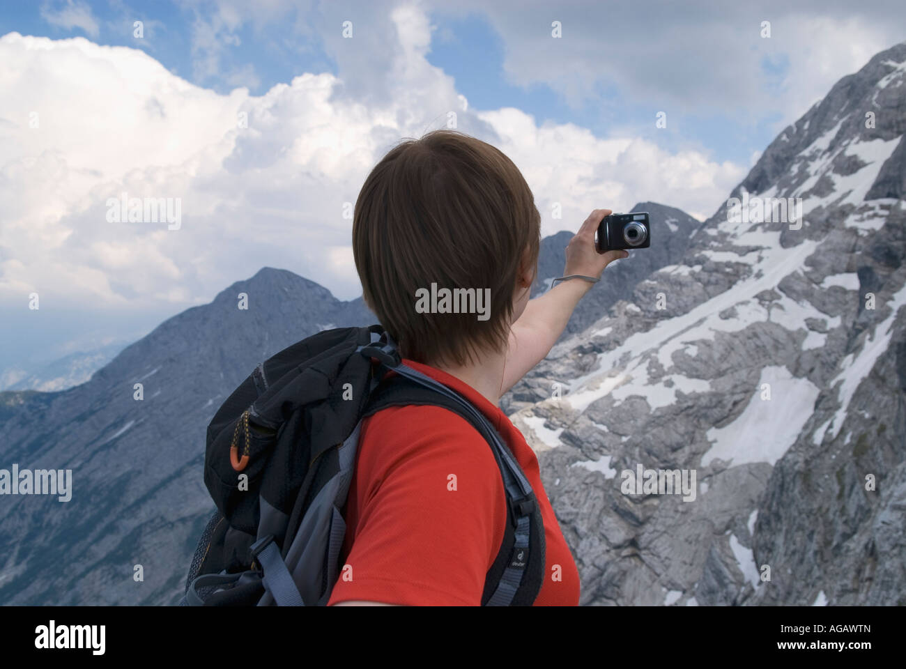 single brunette female hiker taking self portrait high in German Alps ...