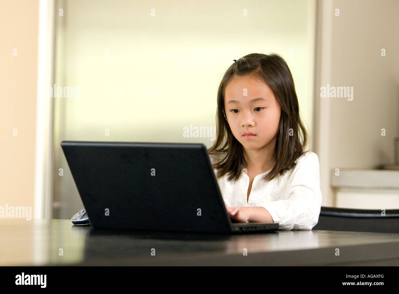 Young Girl on Laptop Stock Photo - Alamy