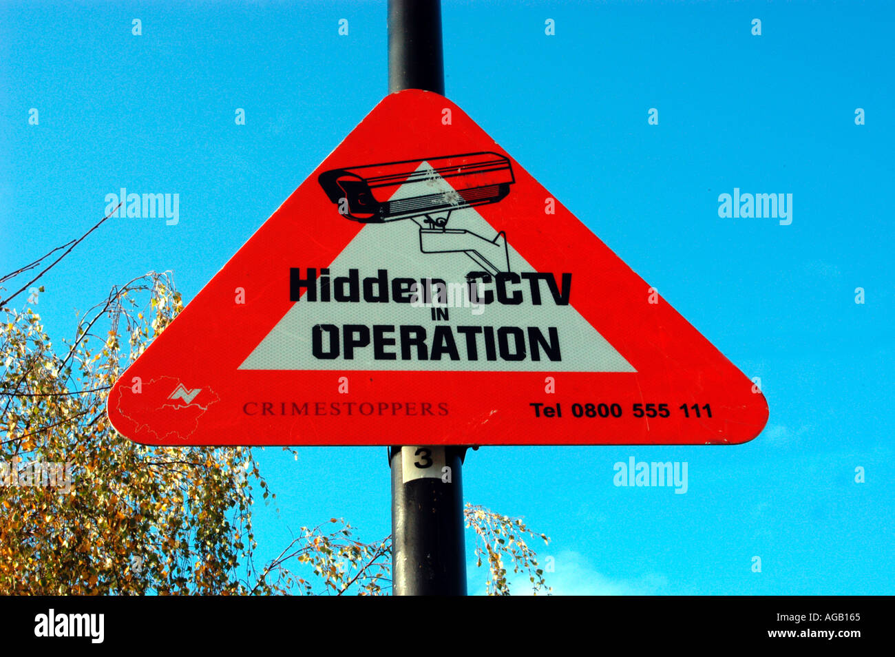 Signpost warning of hidden CCTV camera in operation Stock Photo - Alamy
