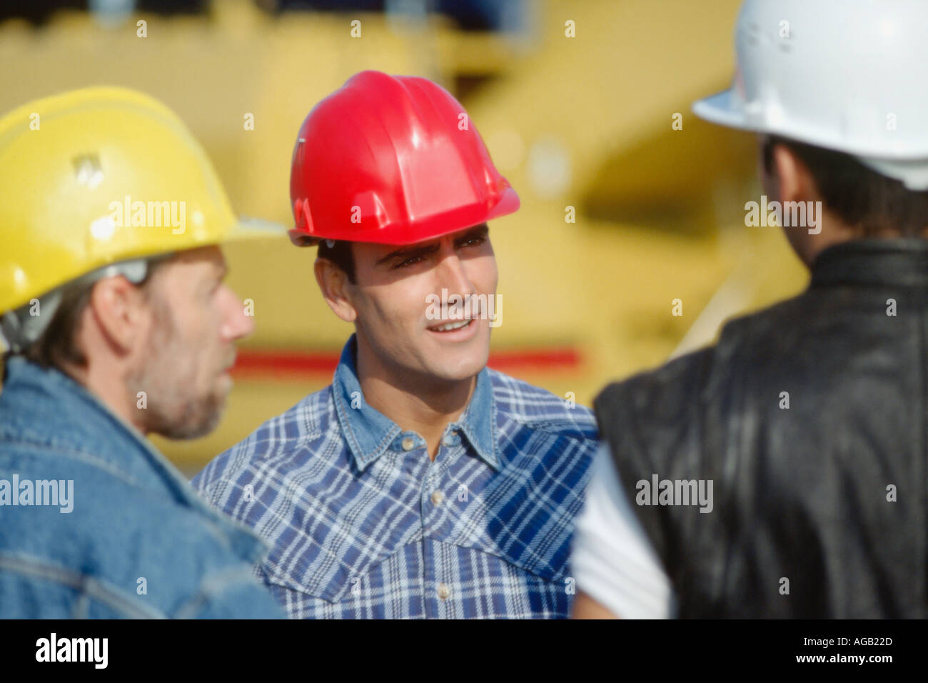Three workers on construction site Stock Photo - Alamy