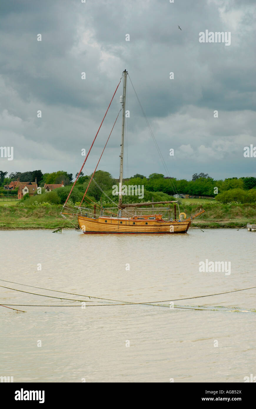 A traditional wooden hull sailing boat moored at Southwold Harbour in ...
