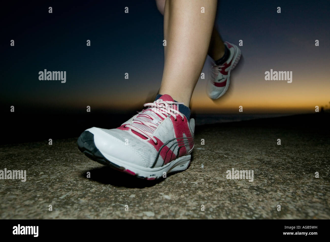 Close up of runners feet with sunset Stock Photo - Alamy