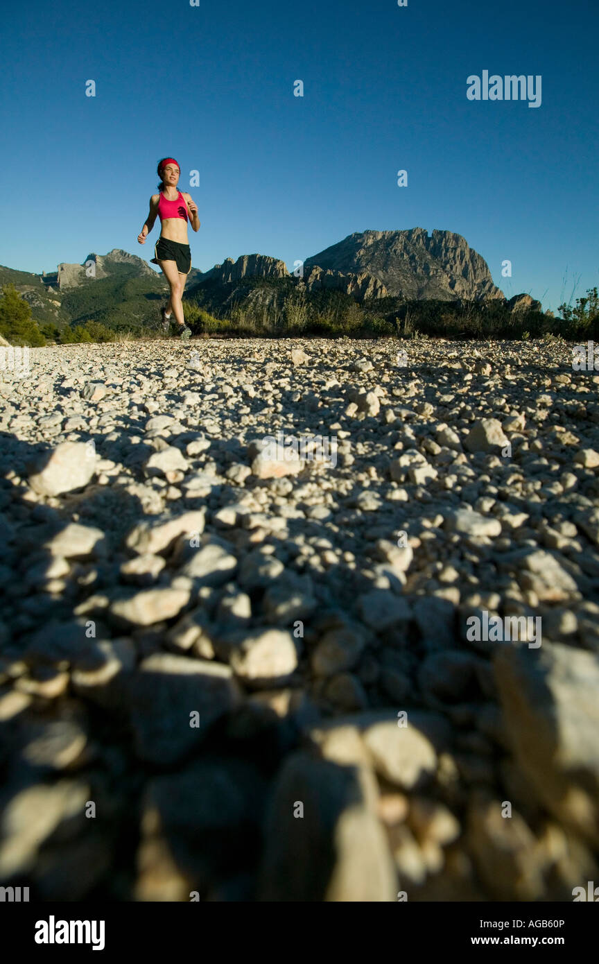 Female trail runner with mountain background Stock Photo - Alamy