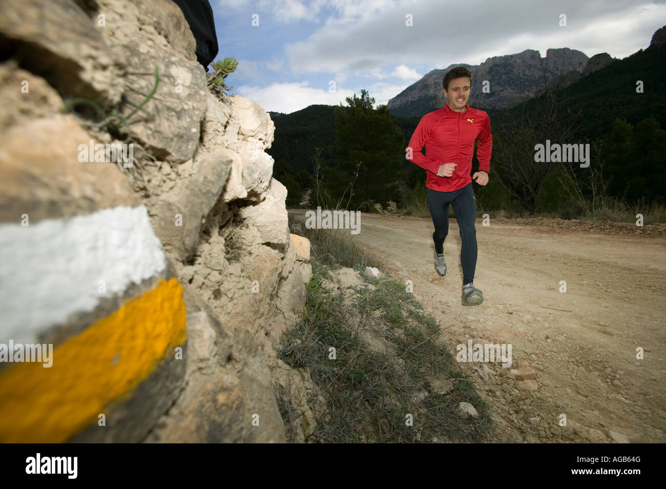 Male runner with trail waymark Stock Photo - Alamy