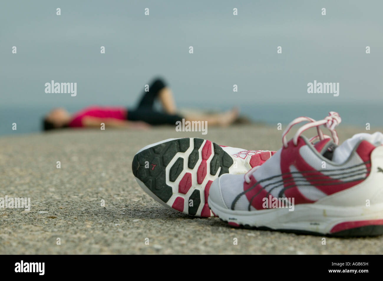 Exhausted female runner resting Stock Photo - Alamy