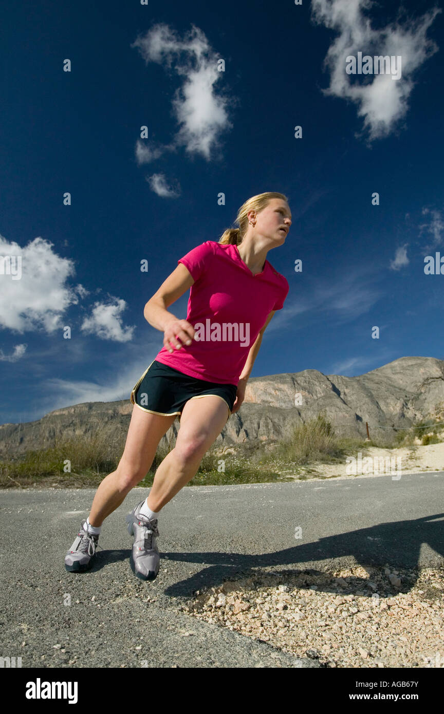 Female runner on scenic road Stock Photo - Alamy