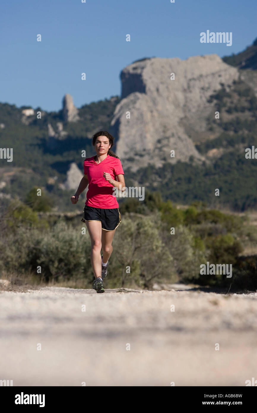 Female runner on mountain trail Stock Photo - Alamy