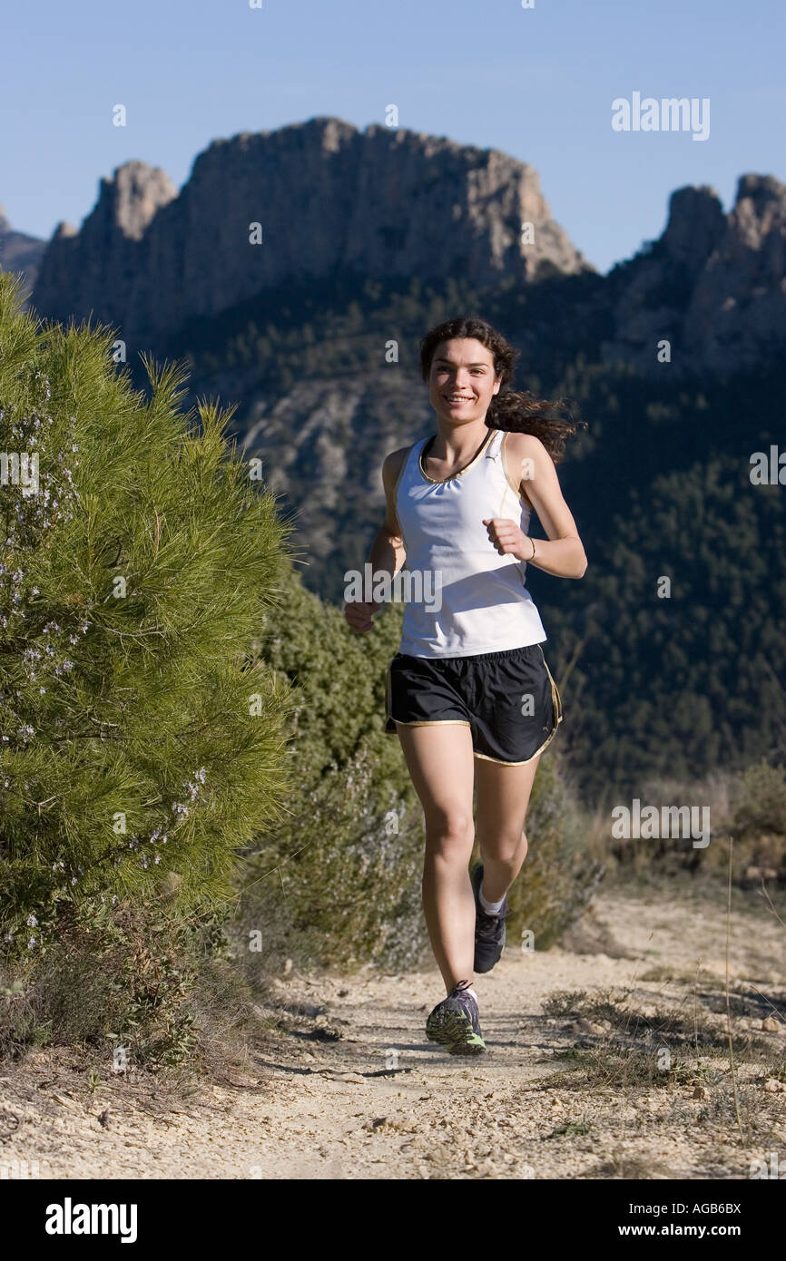 Female runner on mountain trail Stock Photo - Alamy