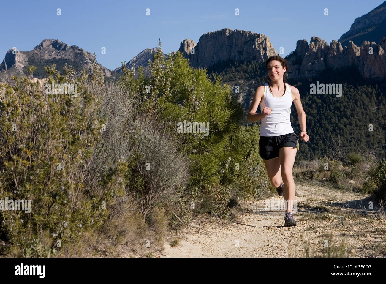 Female runner on mountain trail Stock Photo - Alamy