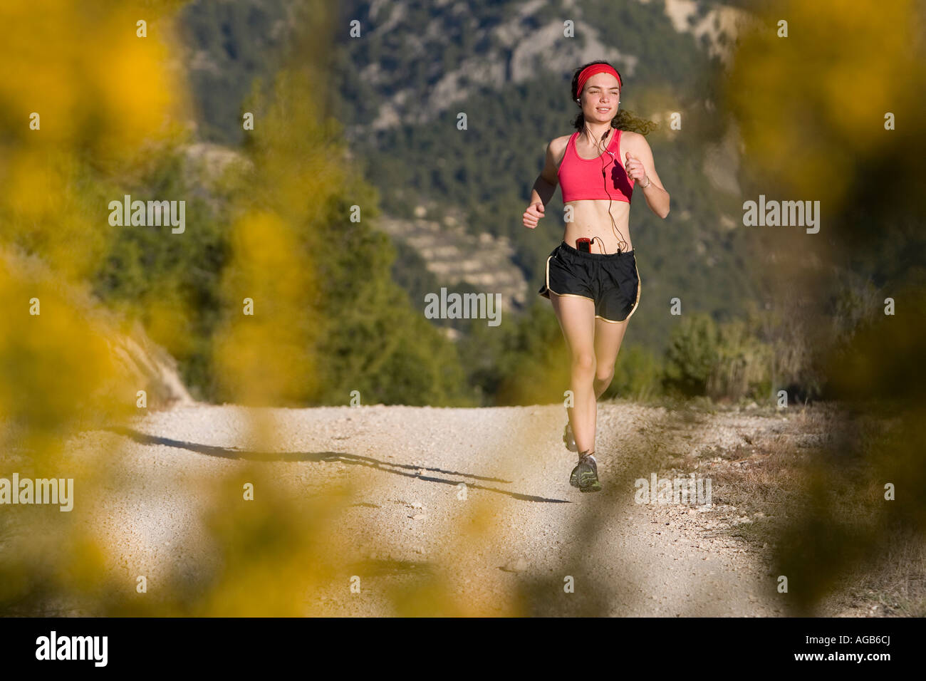 Female runner on mountain trail Stock Photo - Alamy