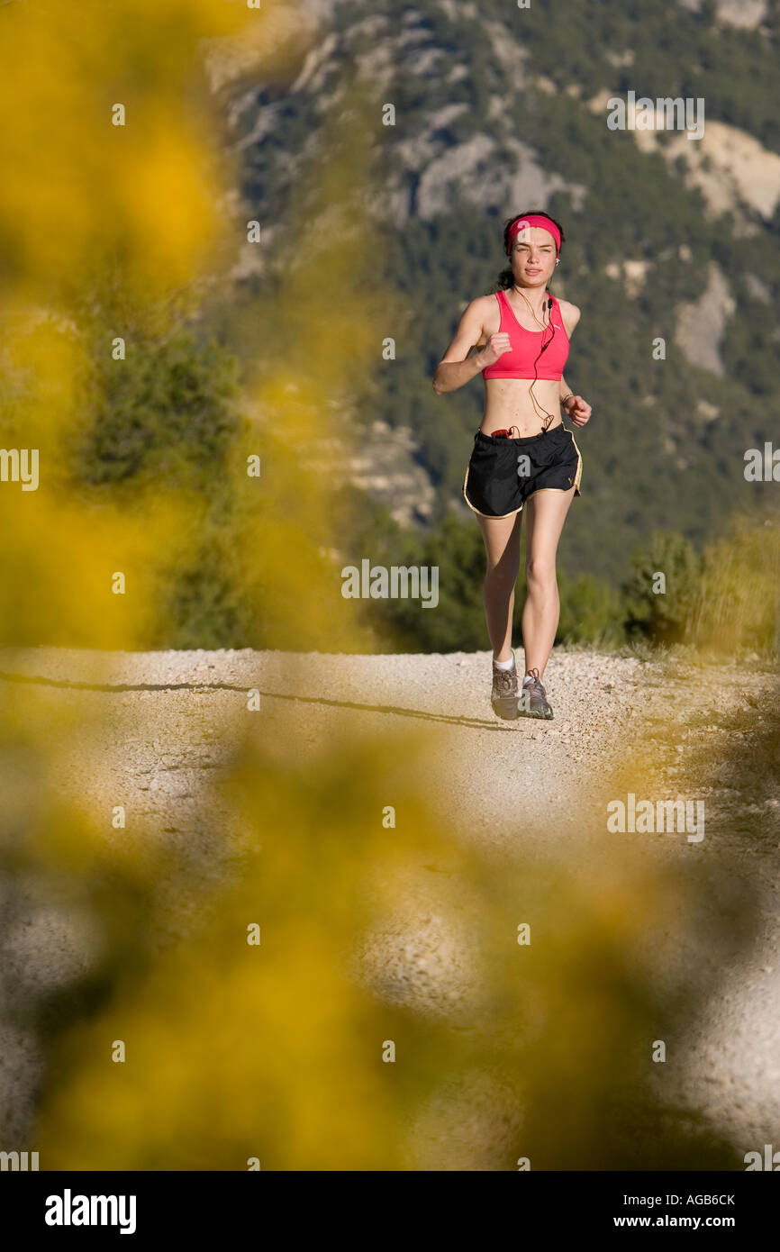 Female runner on mountain trail Stock Photo - Alamy