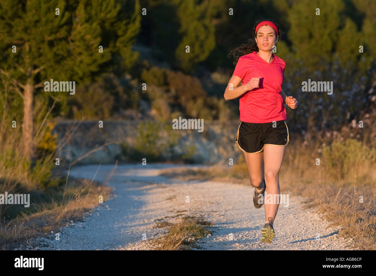 Female runner on mountain trail Stock Photo - Alamy
