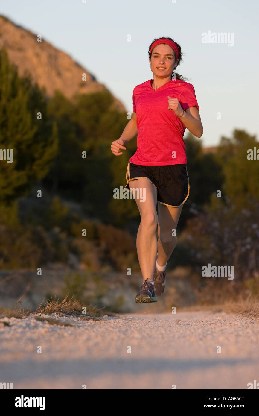 Female runner on mountain trail Stock Photo - Alamy