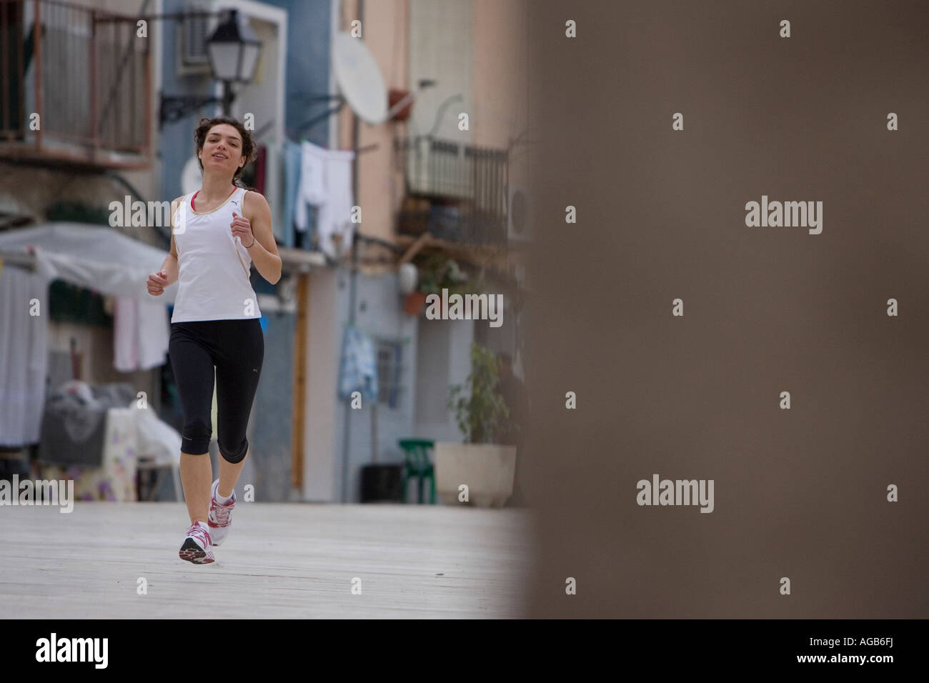 Female running in town Stock Photo - Alamy